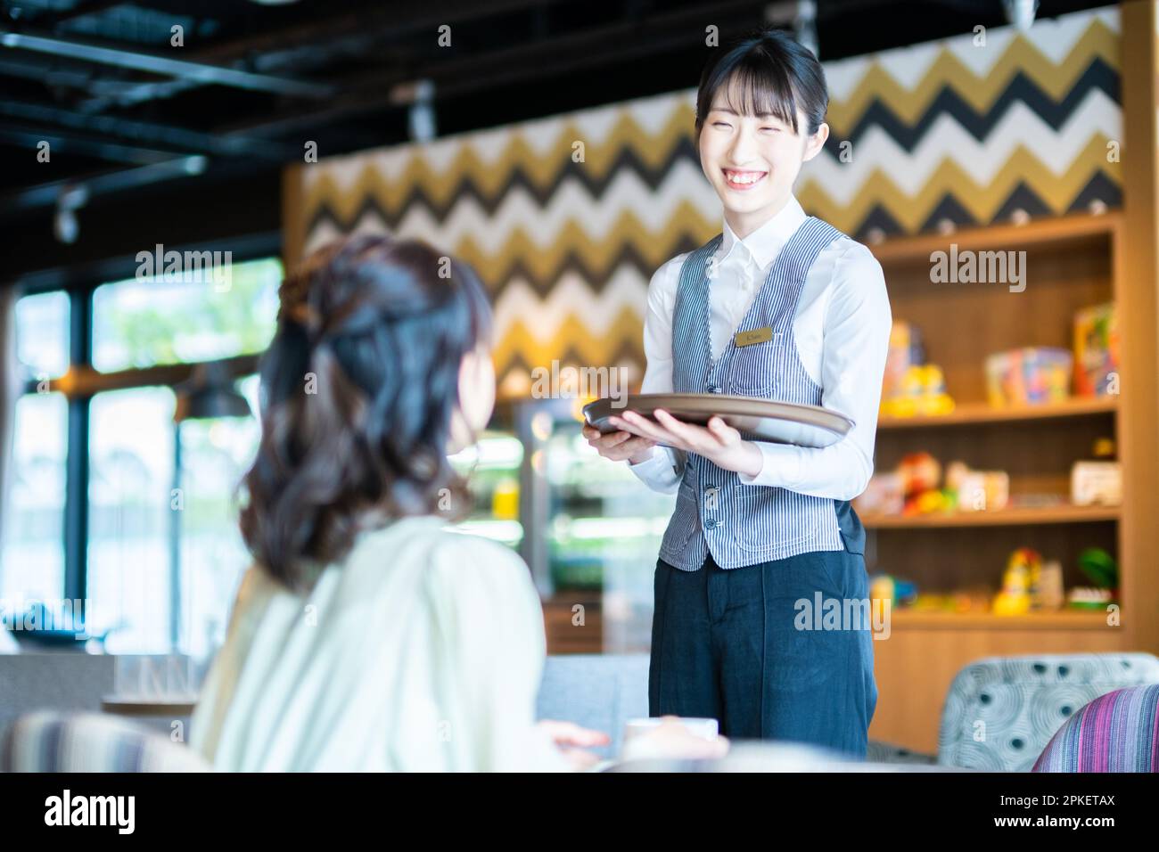 Cafe staff carrying coffee Stock Photo - Alamy