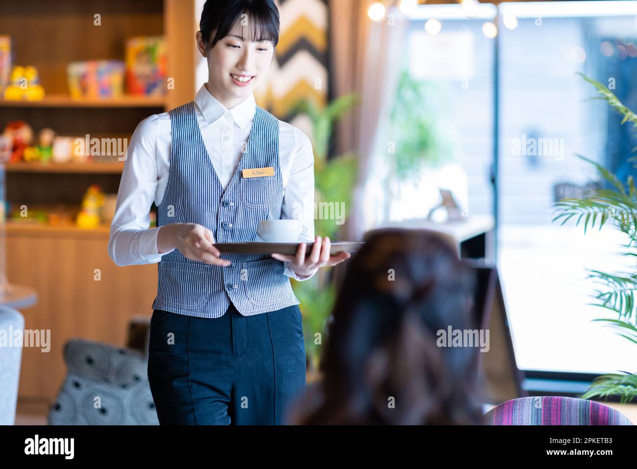 Cafe staff carrying coffee Stock Photo - Alamy