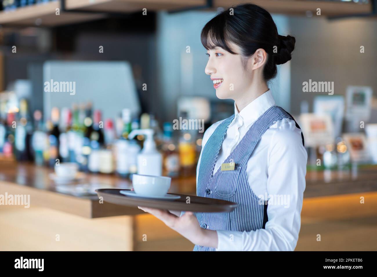 Cafe staff carrying coffee Stock Photo - Alamy