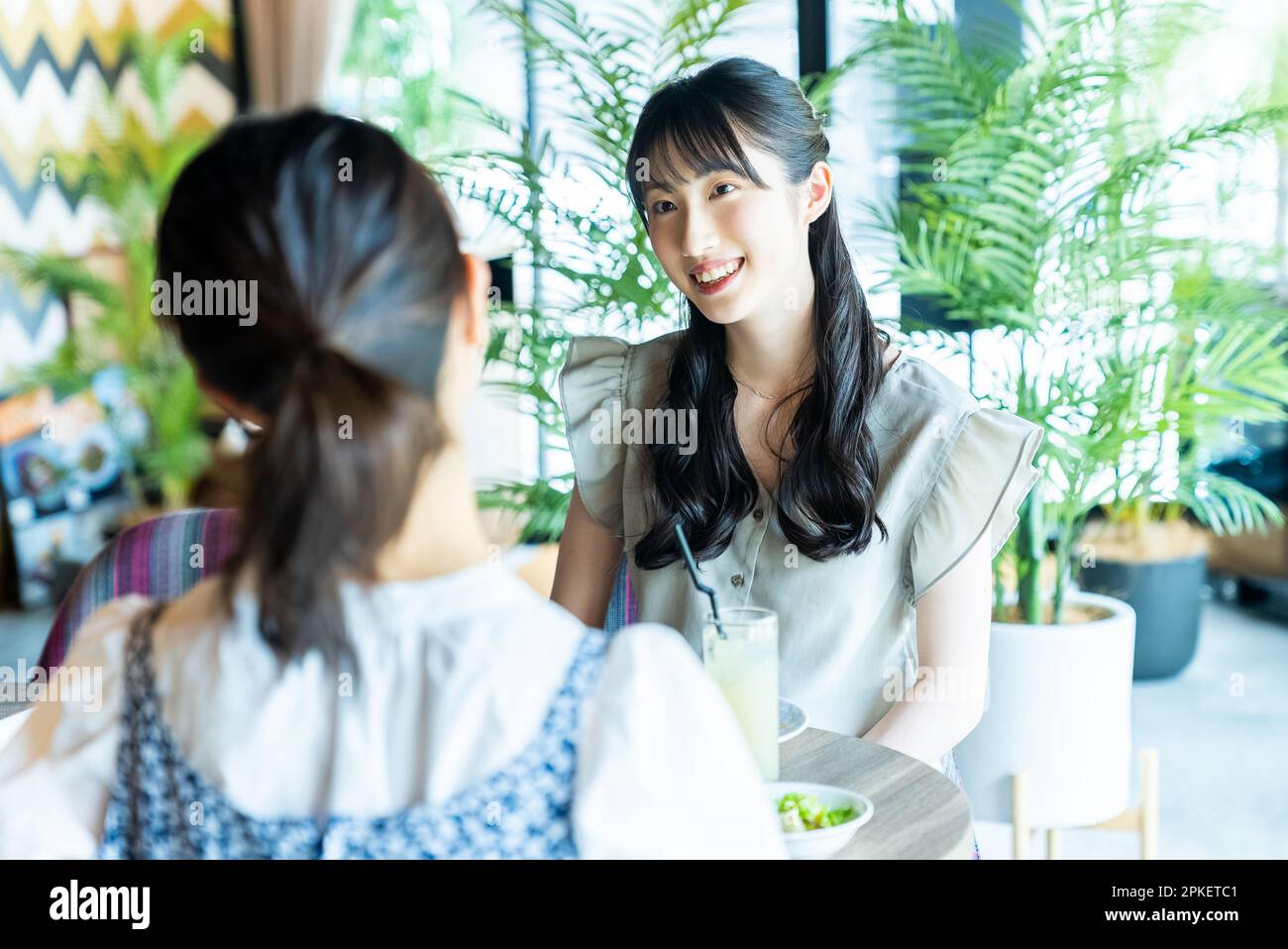 Woman relaxing at a cafe Stock Photo - Alamy