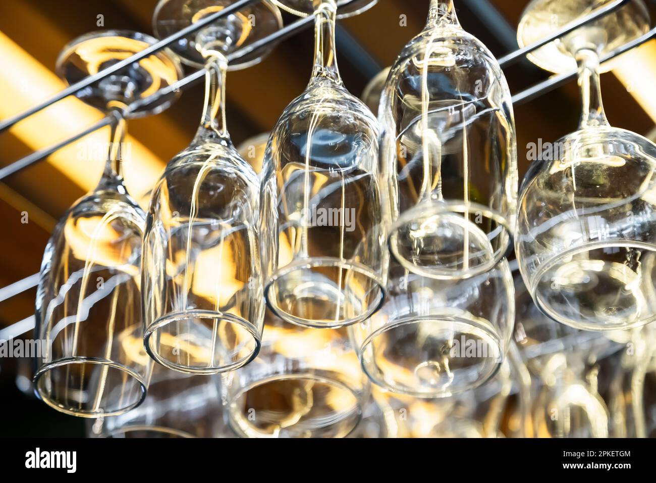 clean wine glasses hang over the bar. Glass, utensils, objects Stock ...