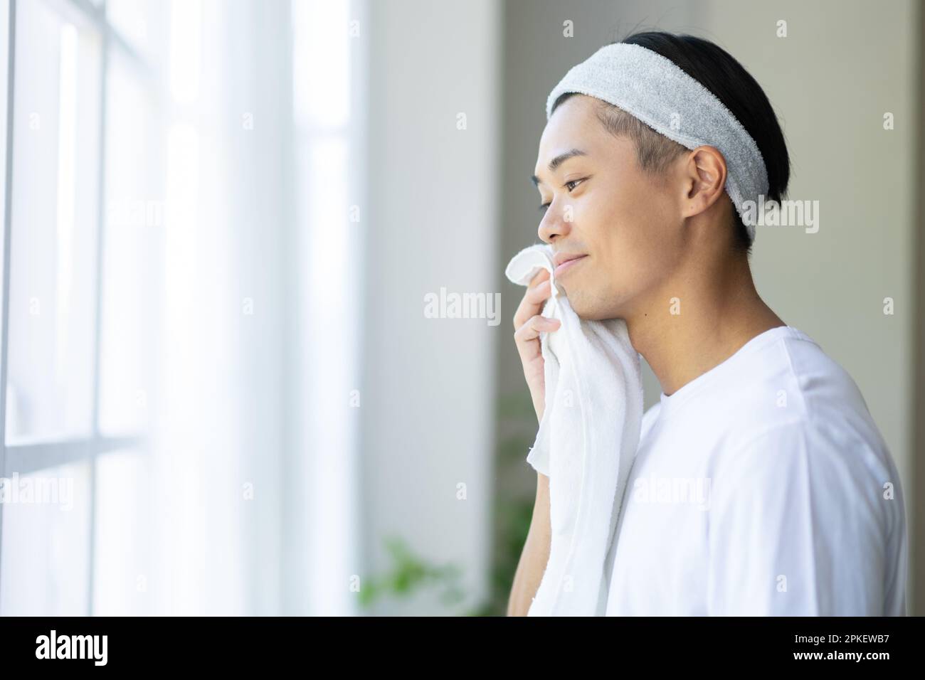 Man wiping his face Stock Photo - Alamy