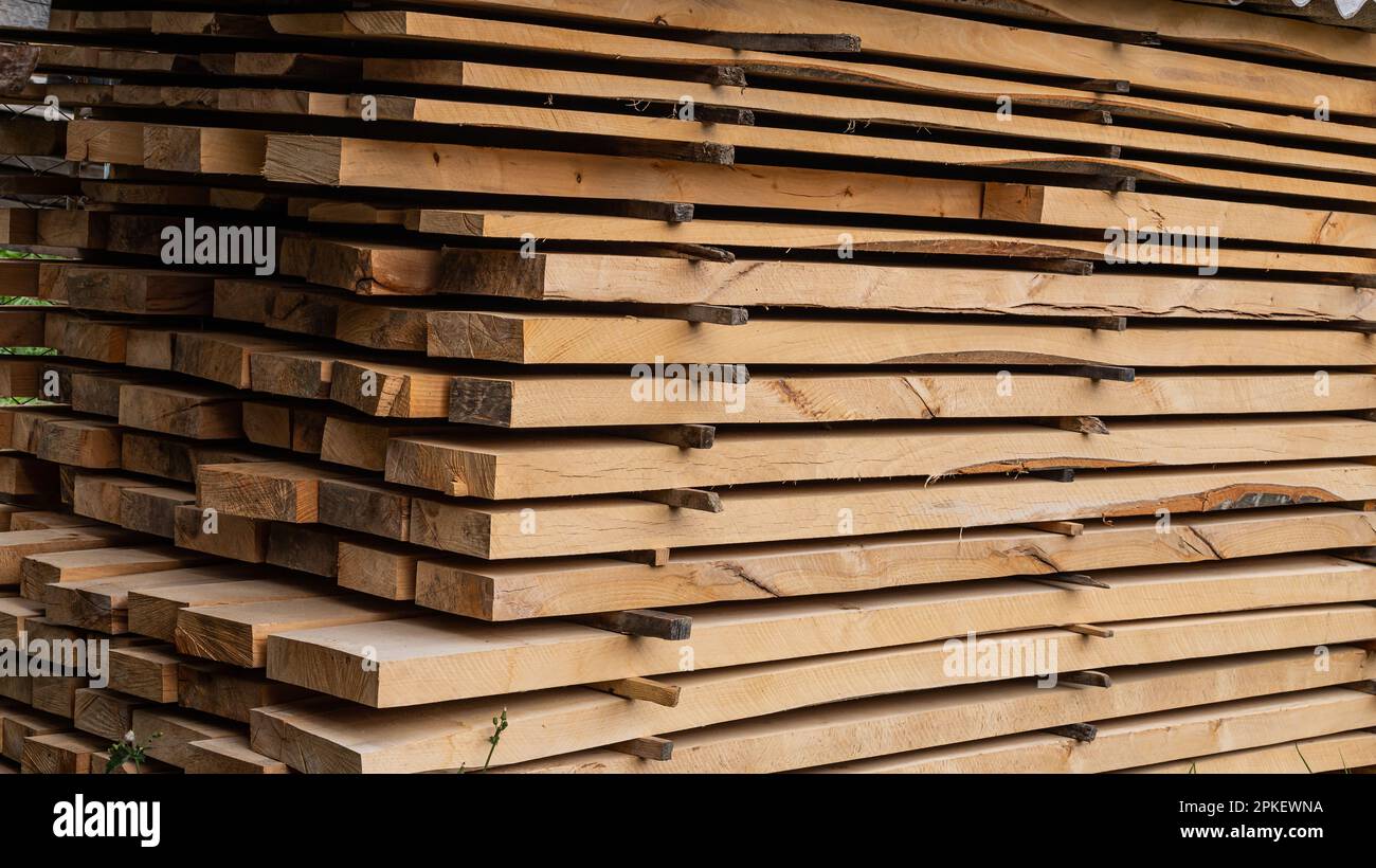 Piles of wooden boards in the sawmill, planking. Warehouse for sawing ...