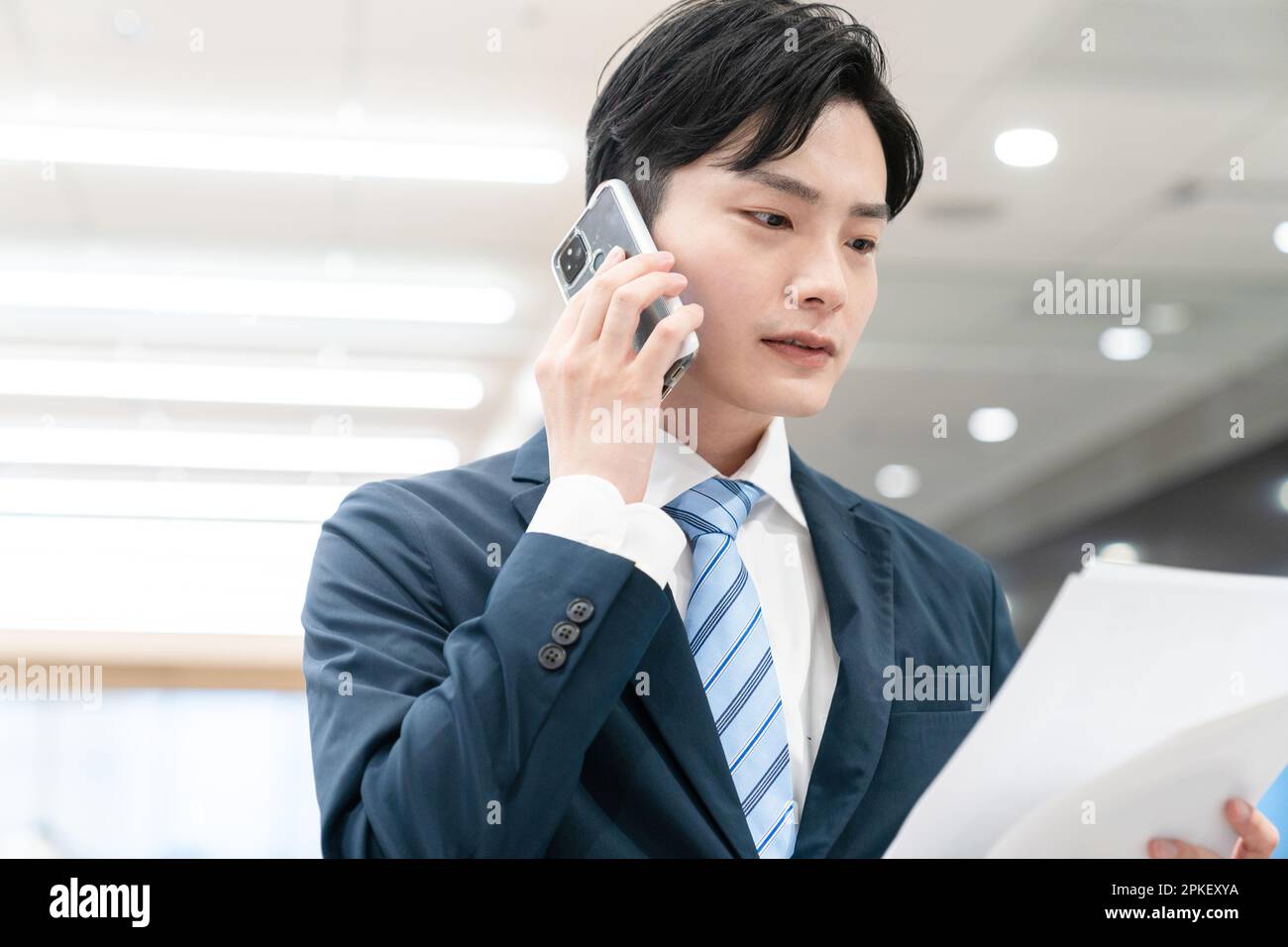 Young businessman working smartphone documents hi-res stock photography ...