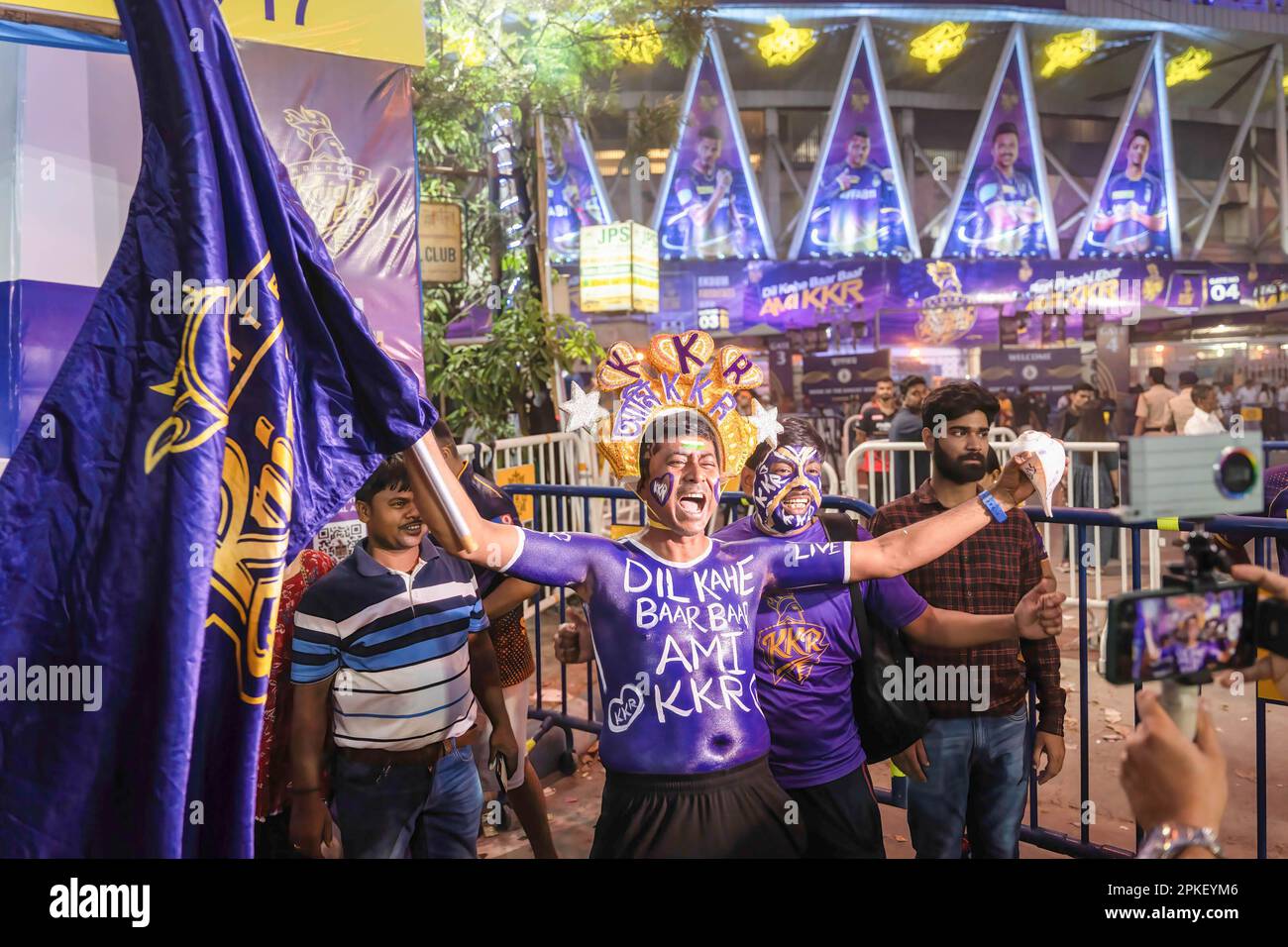 A KKR (Kolkata Knight Riders) supporter painted with KKR slogans on his ...