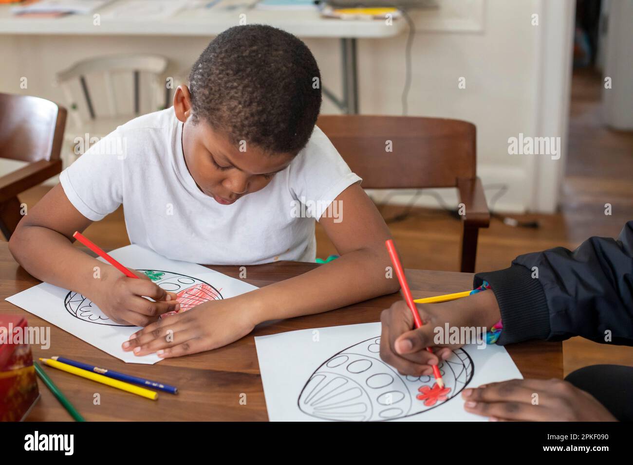 Detroit, Michigan - Children color easter egg outlines in an art ...