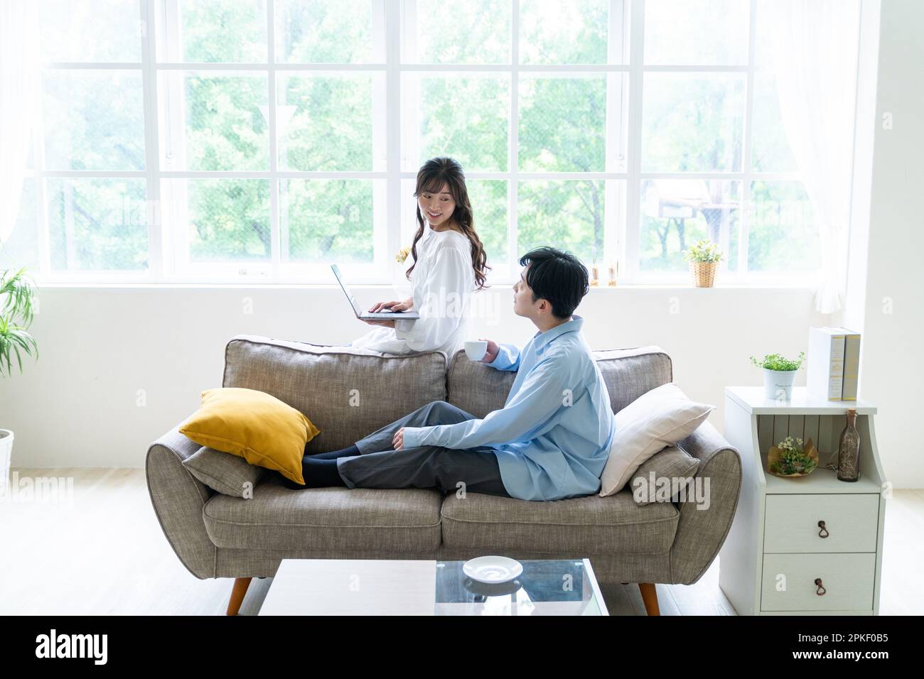 Man and woman relaxing in a room Stock Photo - Alamy