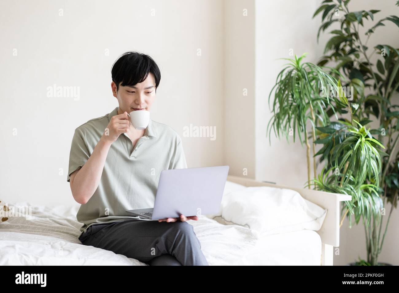 Man relaxing in bed Stock Photo - Alamy