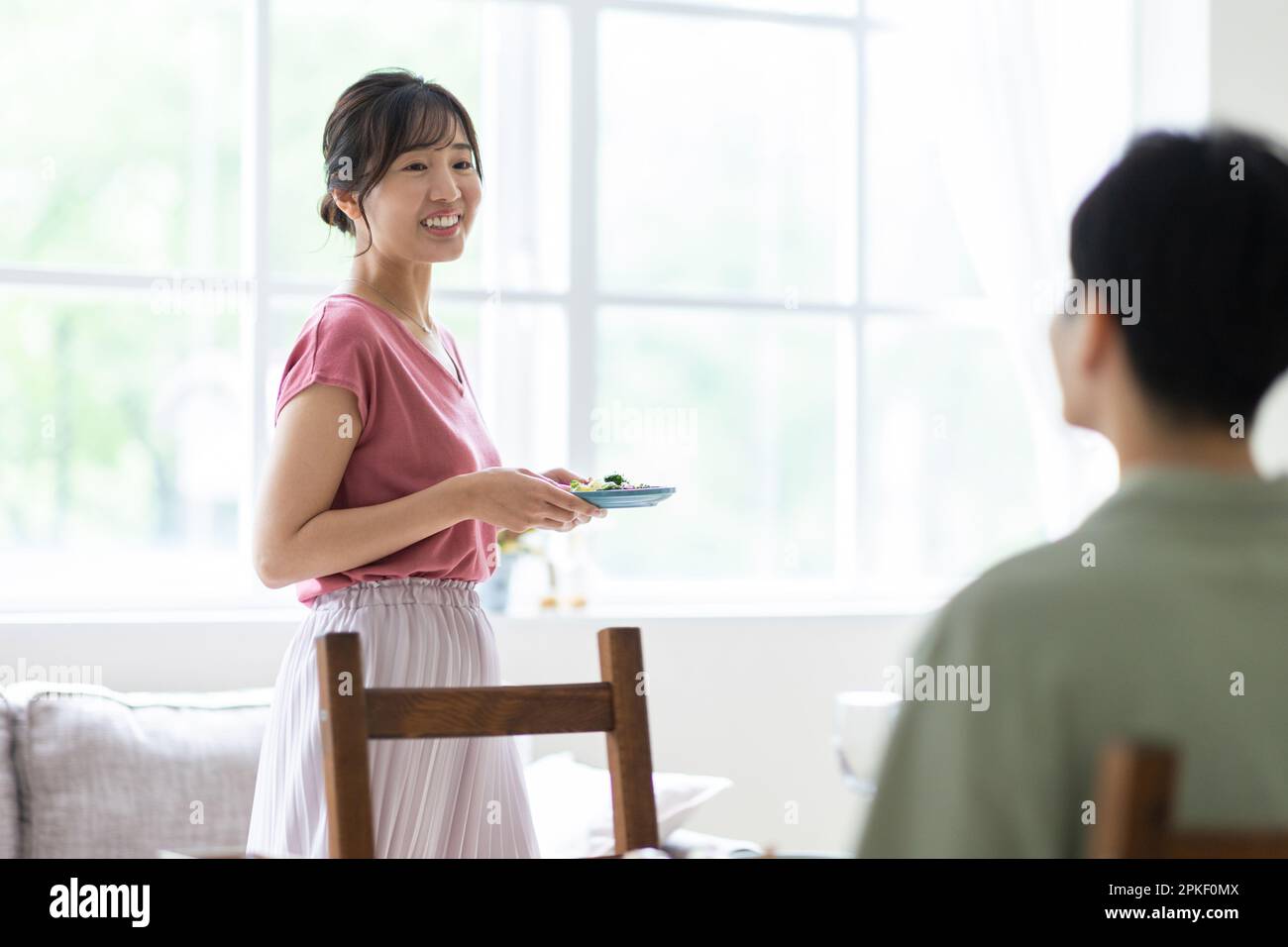 Woman carrying a meal Stock Photo - Alamy