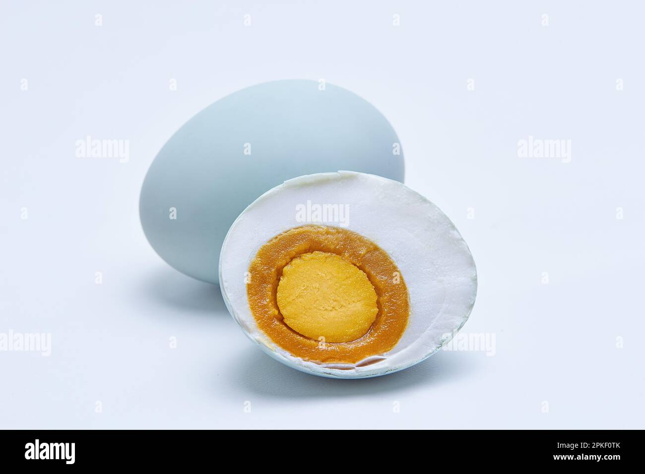 Salted duck eggs ( Telur Asin ) with one egg cut in half to expose the ...