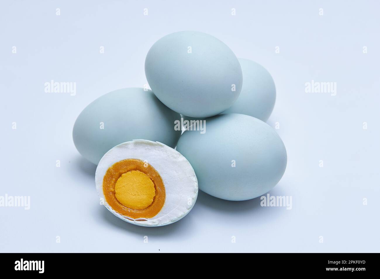 Salted duck eggs ( Telur Asin ) with one egg cut in half to expose the ...