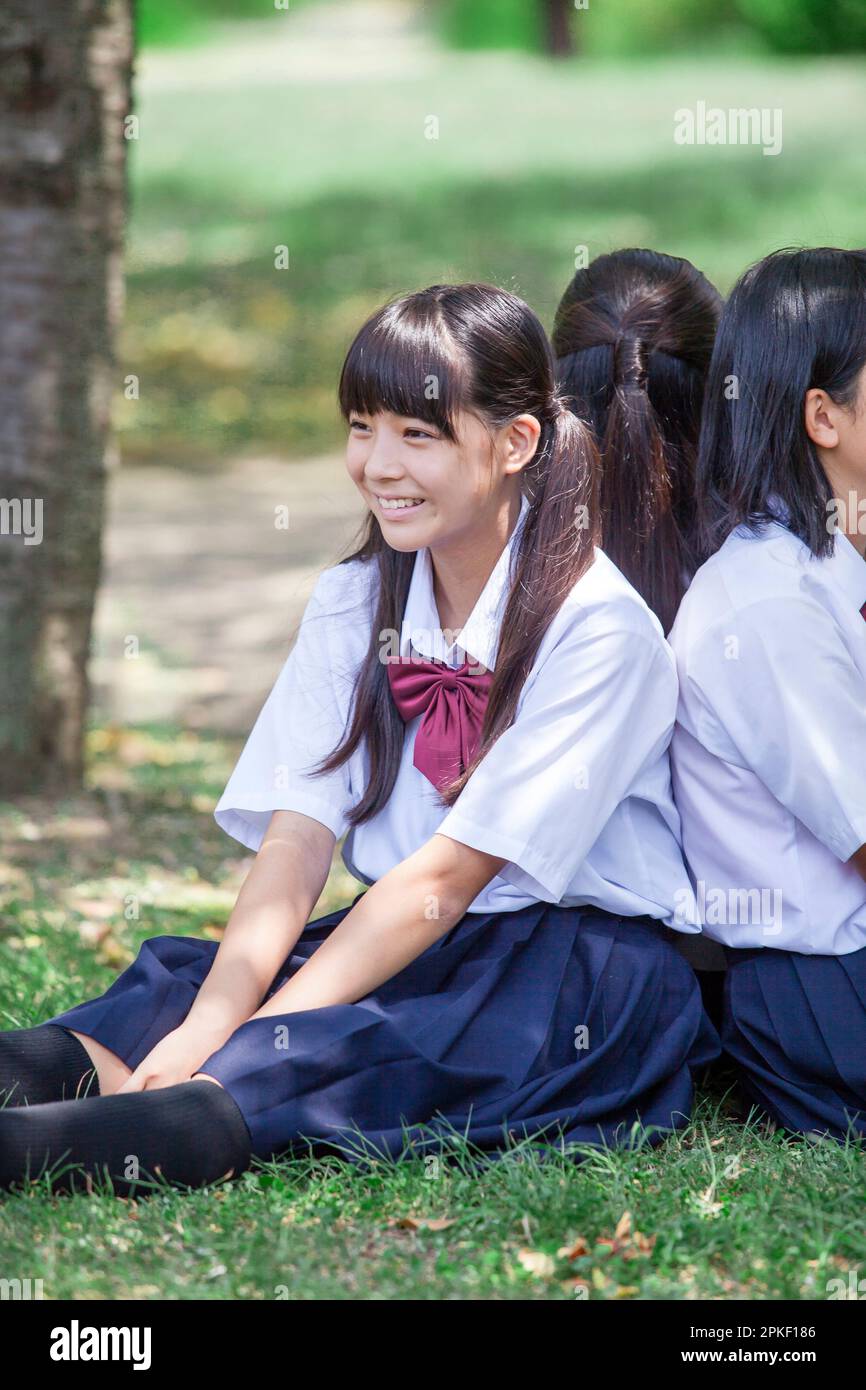 Junior High School Students Sitting Back to Back on a Field Stock Photo ...