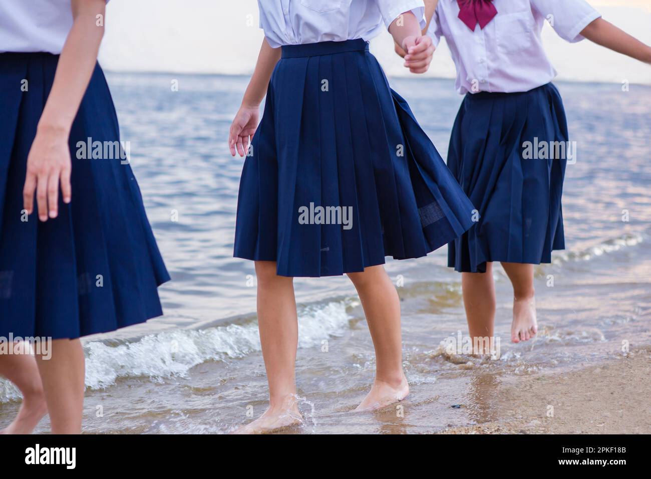 Junior high school students walking on the beach Stock Photo - Alamy