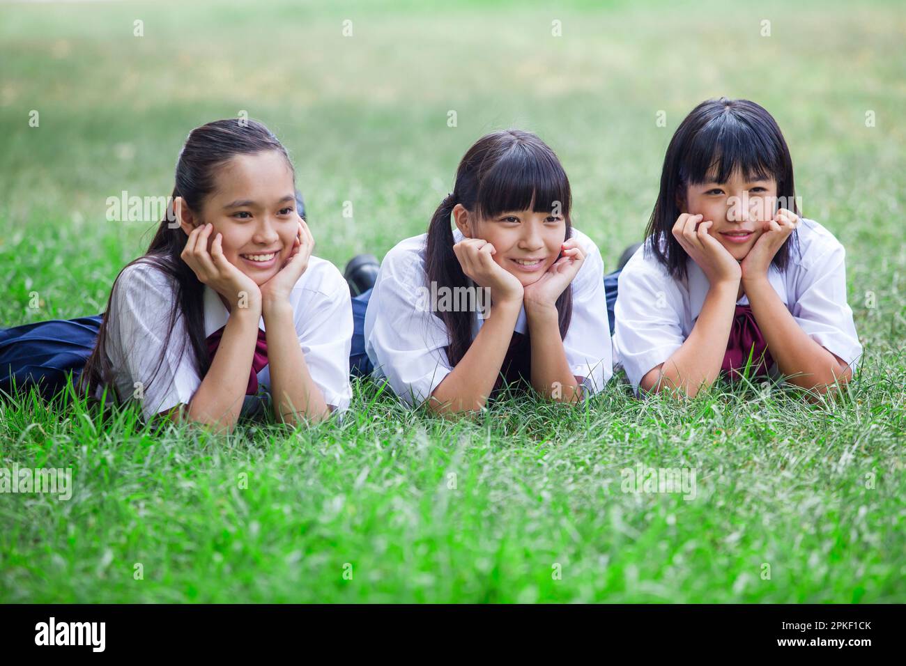 Junior high school student lying on his cheek on the field Stock Photo ...