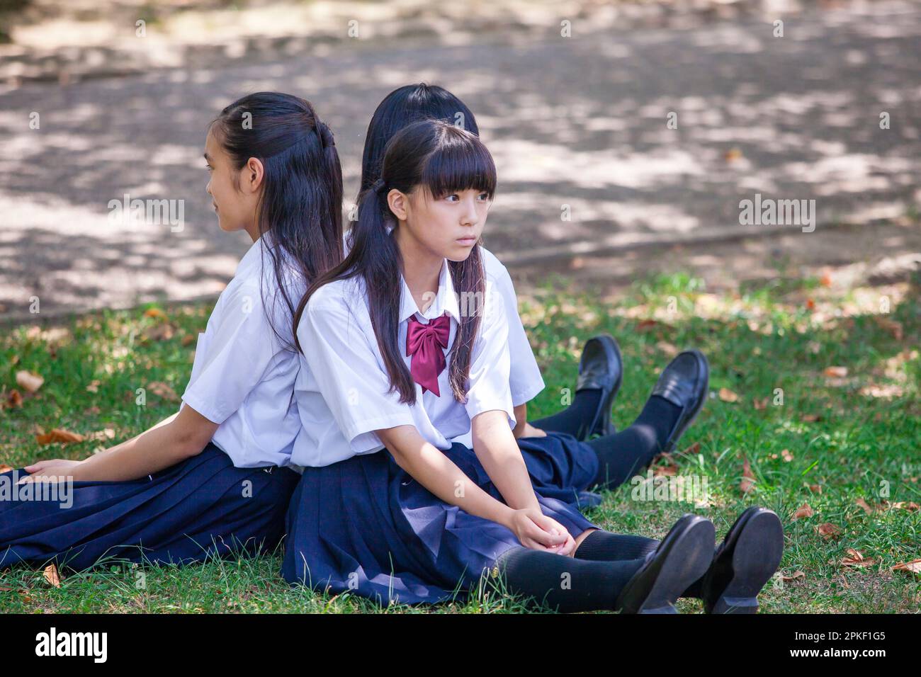 Junior High School Students Sitting Back to Back on a Field Stock Photo ...