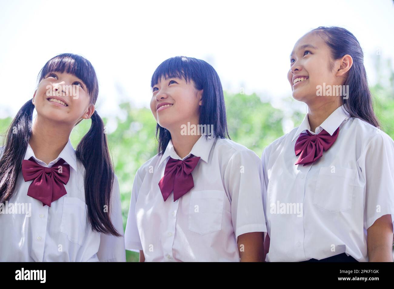 Standing junior high school students looking up in a row Stock Photo ...