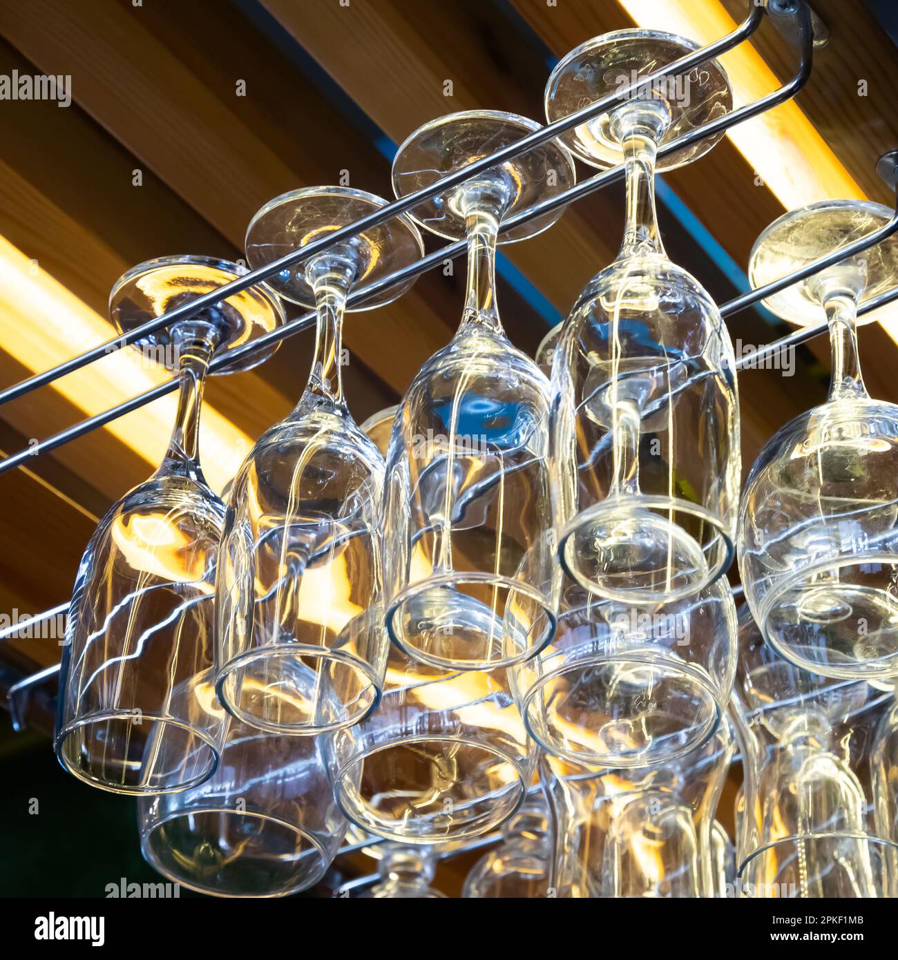 clean wine glasses hang over the bar. Glass, utensils, objects Stock ...