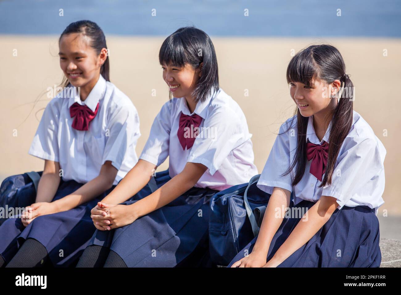 Junior high school students sitting in a line Stock Photo - Alamy