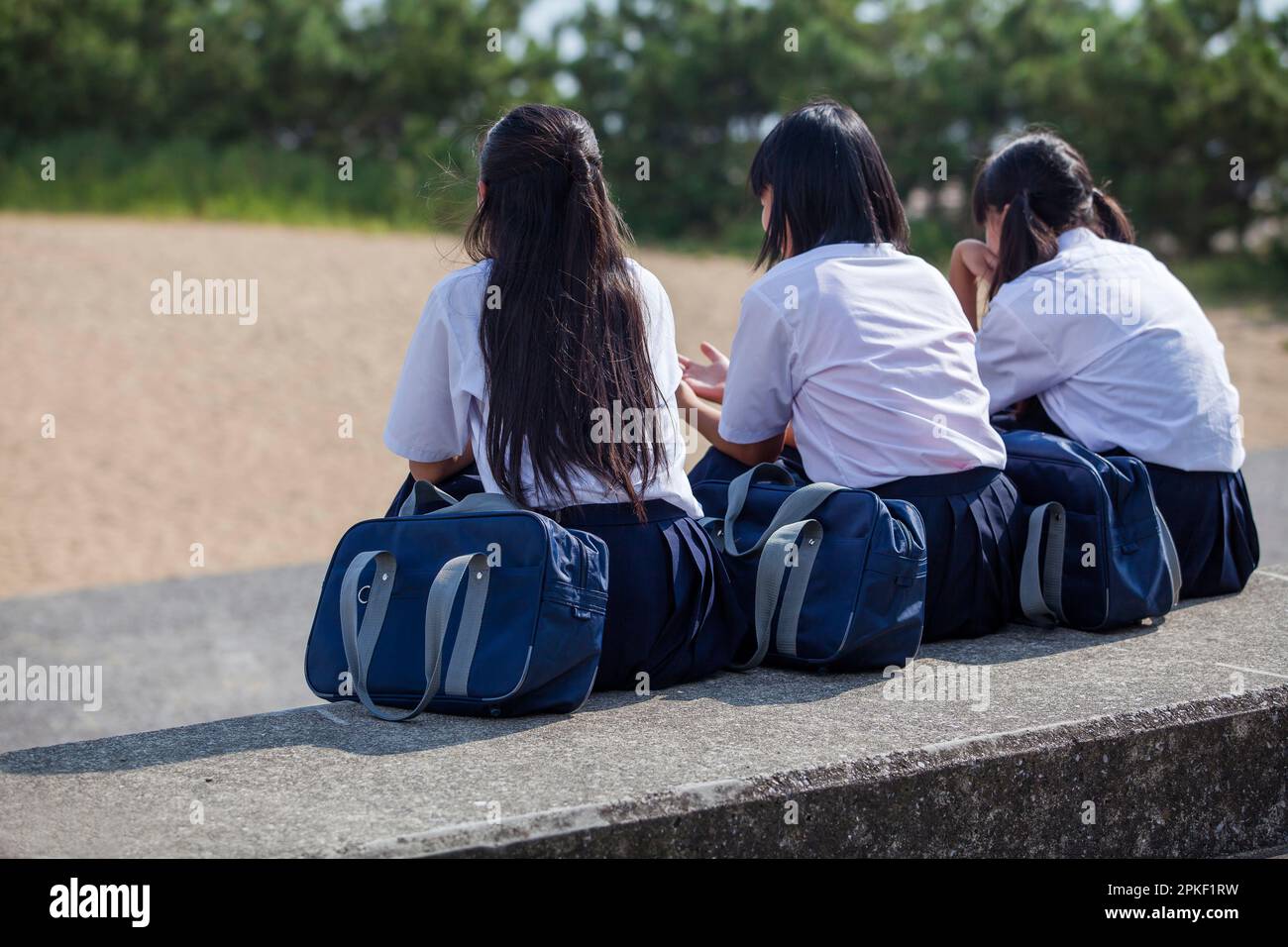 Junior high school students sitting side by side Stock Photo - Alamy