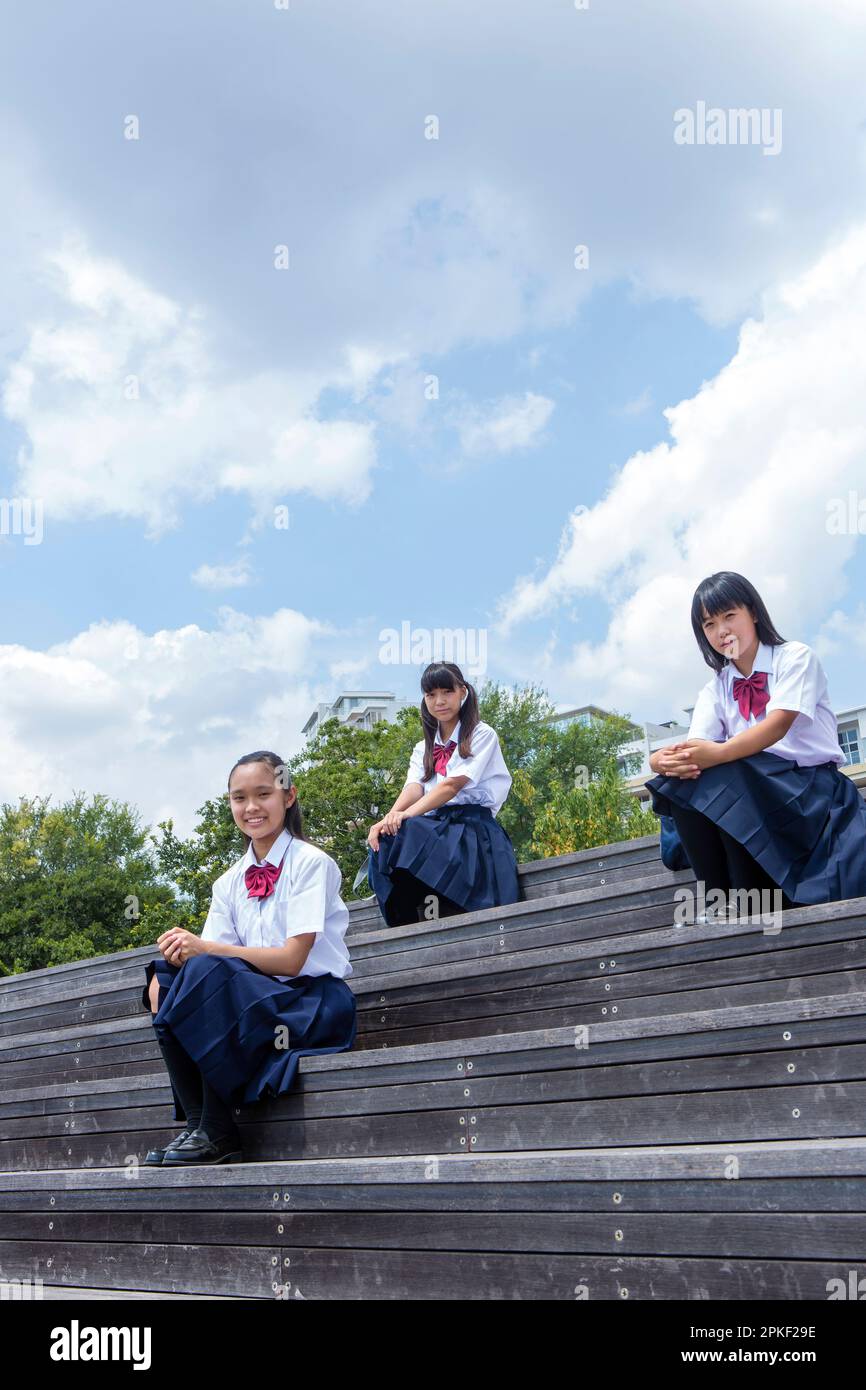 Junior high school students sitting on the stairs Stock Photo - Alamy