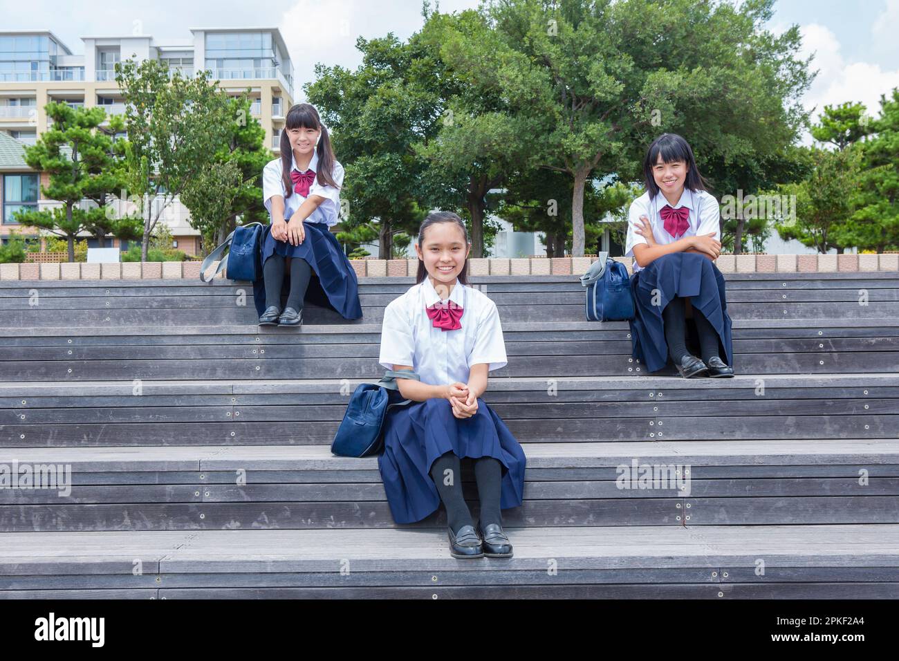 Junior high school students sitting on the stairs Stock Photo - Alamy