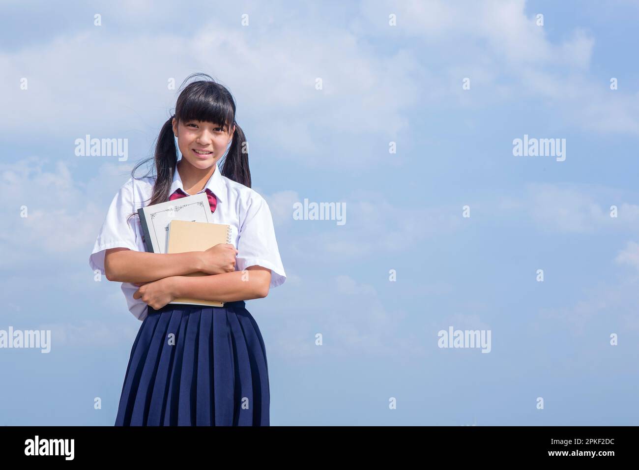 A Junior High School Student Holding a Notebook on the Beach Stock ...