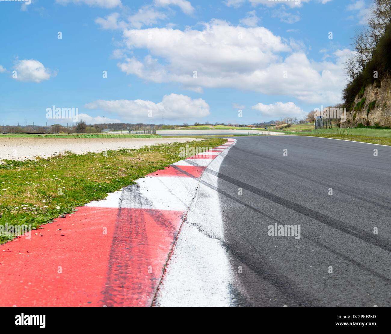 Motor sport asphalt race track and curbs with skid marks, low angle ...