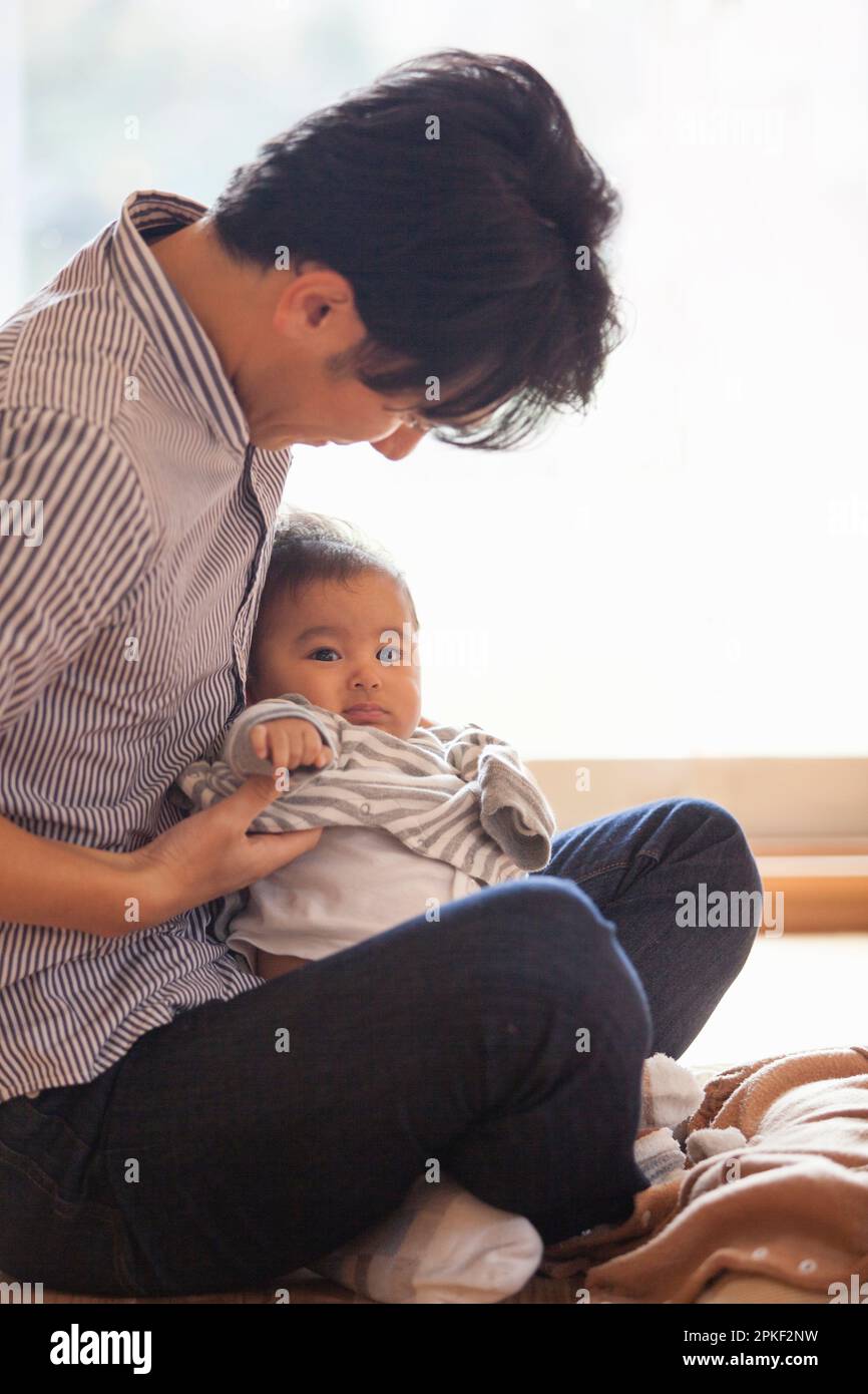 Father taking care of baby hi-res stock photography and images - Alamy