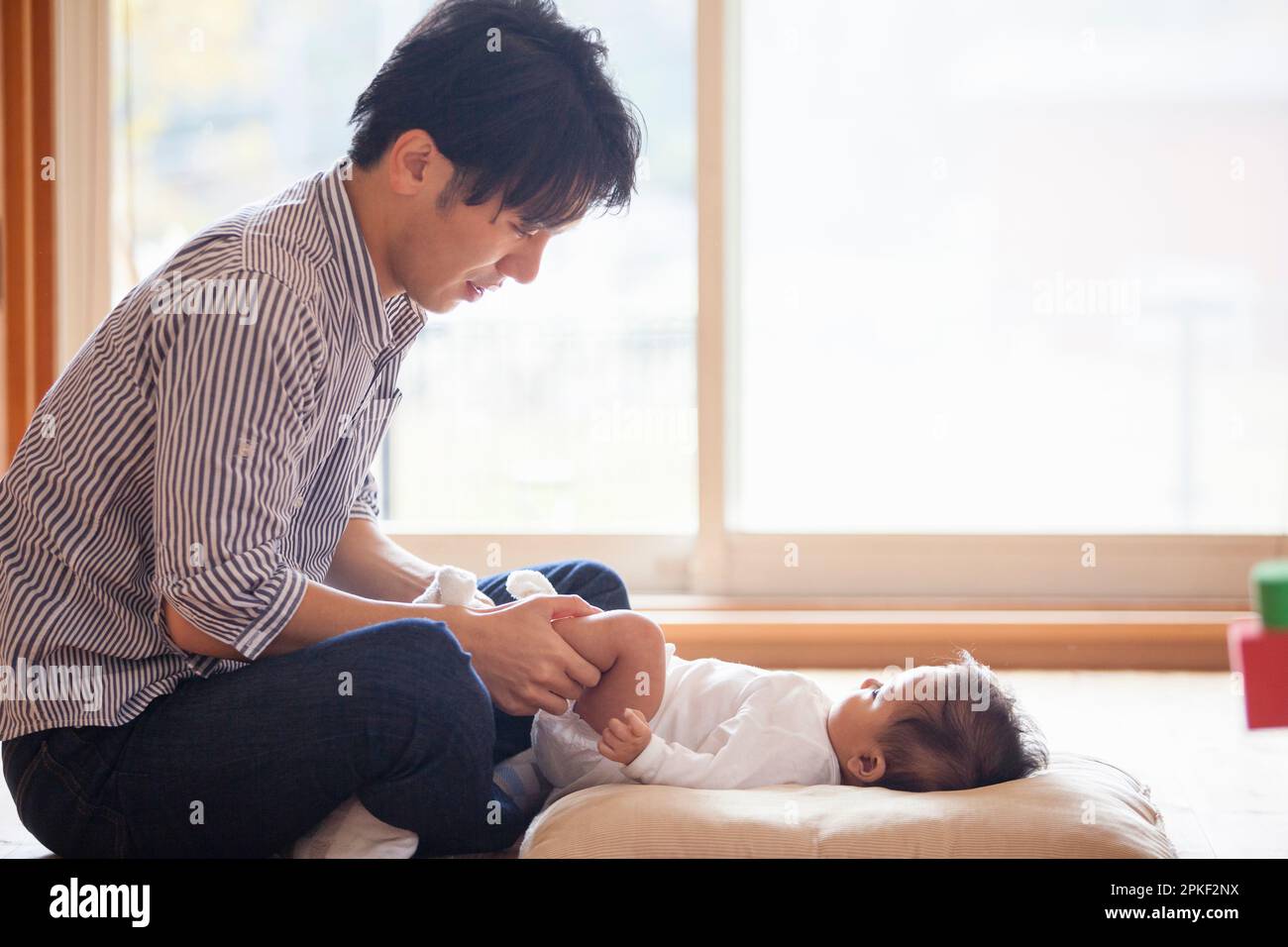 Father taking care of baby Stock Photo - Alamy