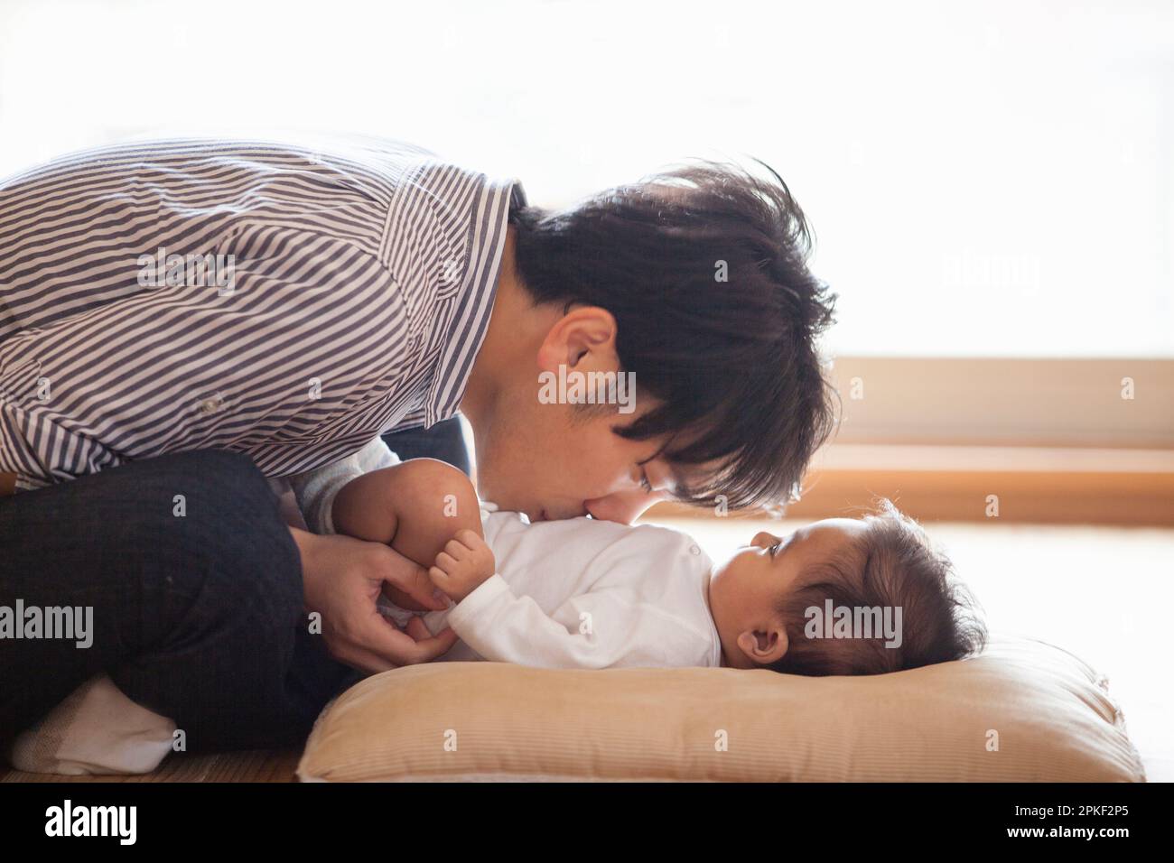 Father taking care of baby Stock Photo - Alamy