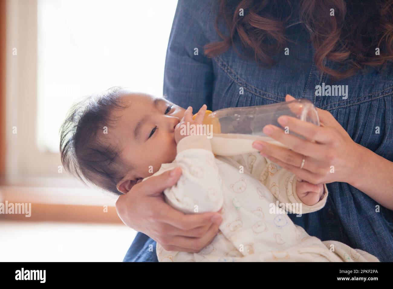 Mother taking care of baby Stock Photo - Alamy