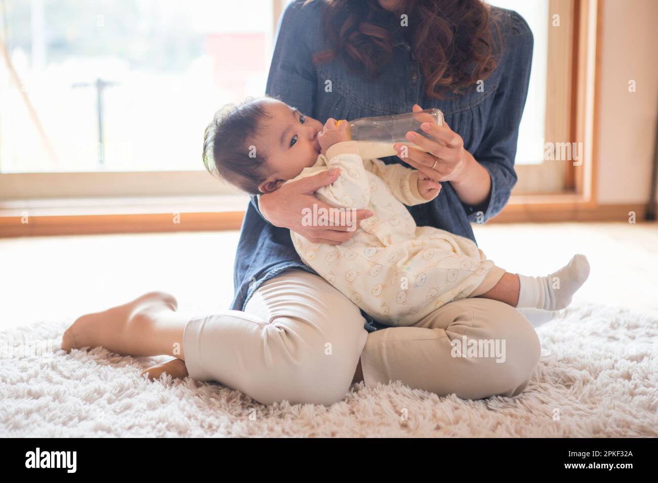 Mothers taking care of children Stock Photo - Alamy