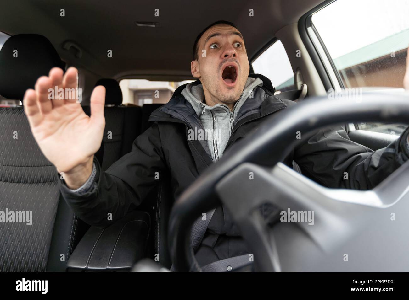 Worried man travelling by car Stock Photo - Alamy