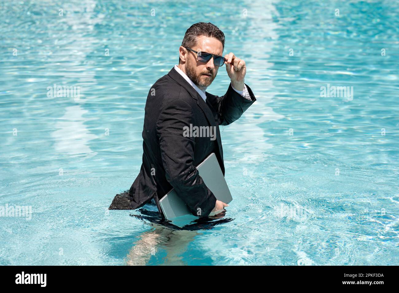 Successful businessman in suit in pool water. Summer vacations and ...