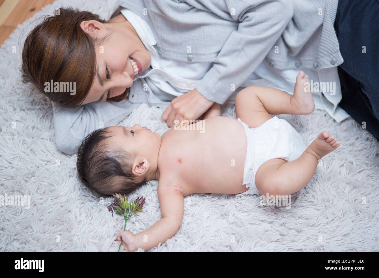 Mother caring for baby Stock Photo - Alamy