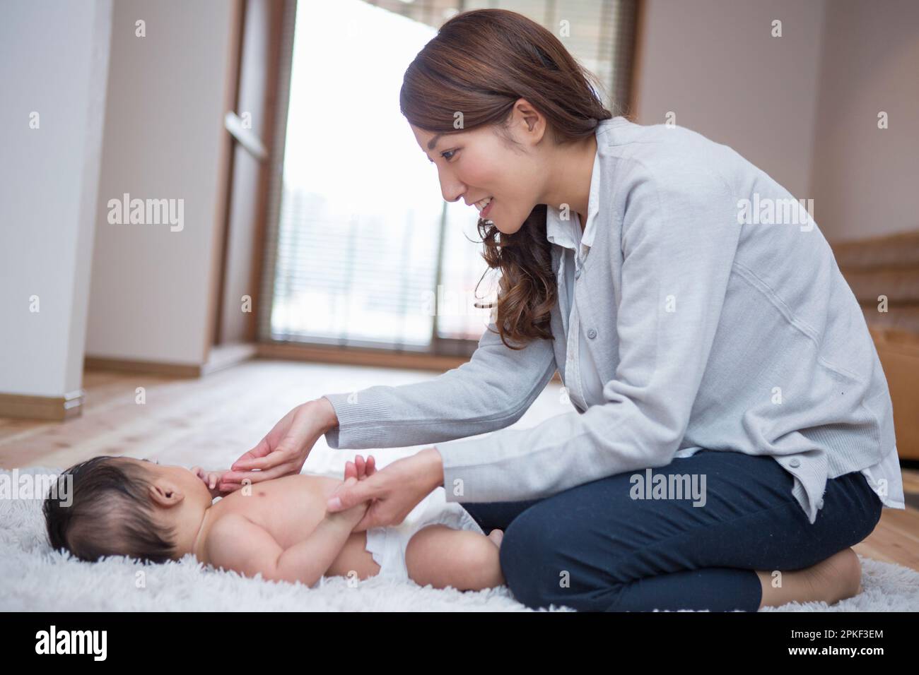 Mother taking care of baby Stock Photo - Alamy