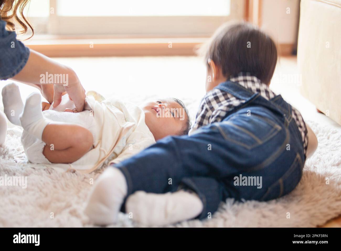 Boy cuddling baby brother hi-res stock photography and images - Alamy