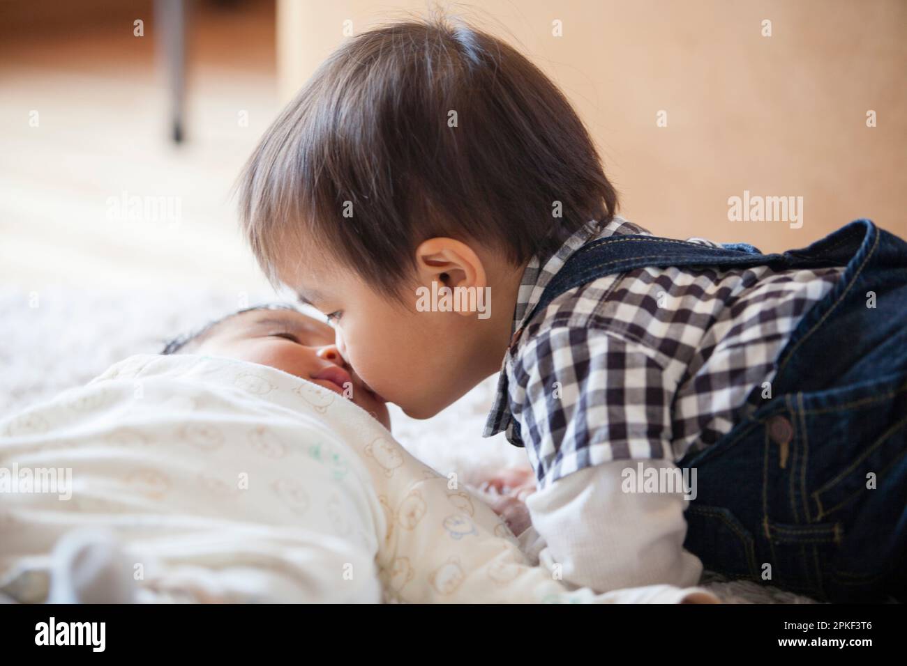 Baby and Boy Stock Photo - Alamy