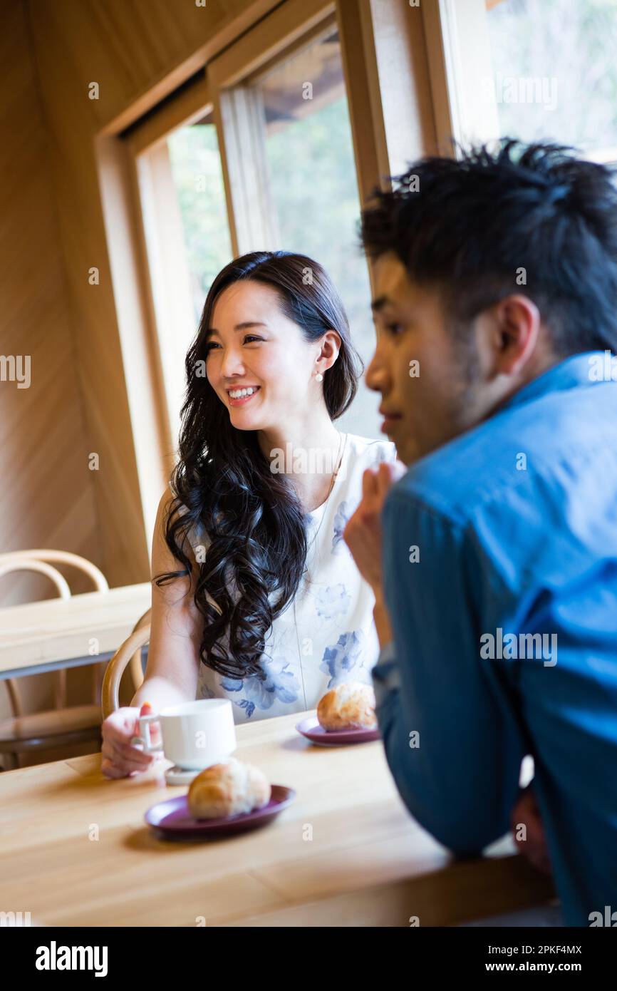 Men and women relaxing at a cafe Stock Photo - Alamy