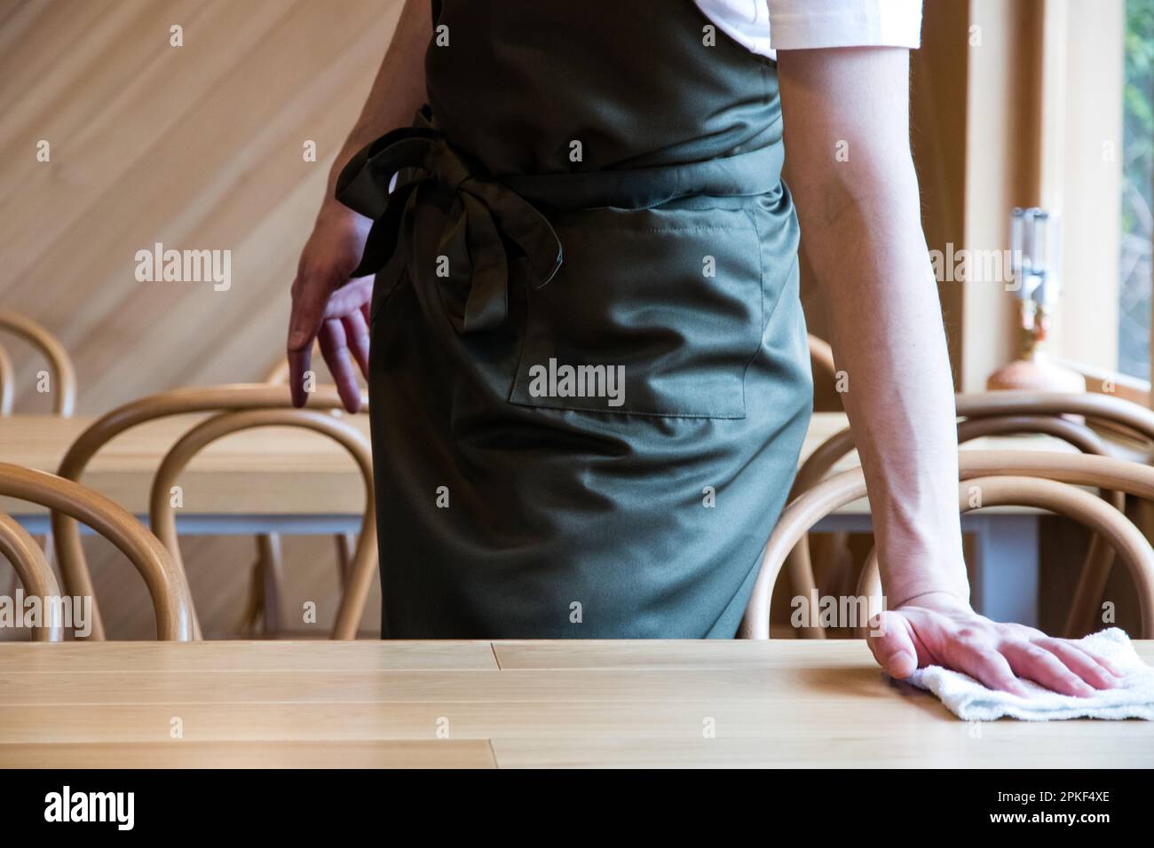 Cafe worker cleaning Stock Photo - Alamy