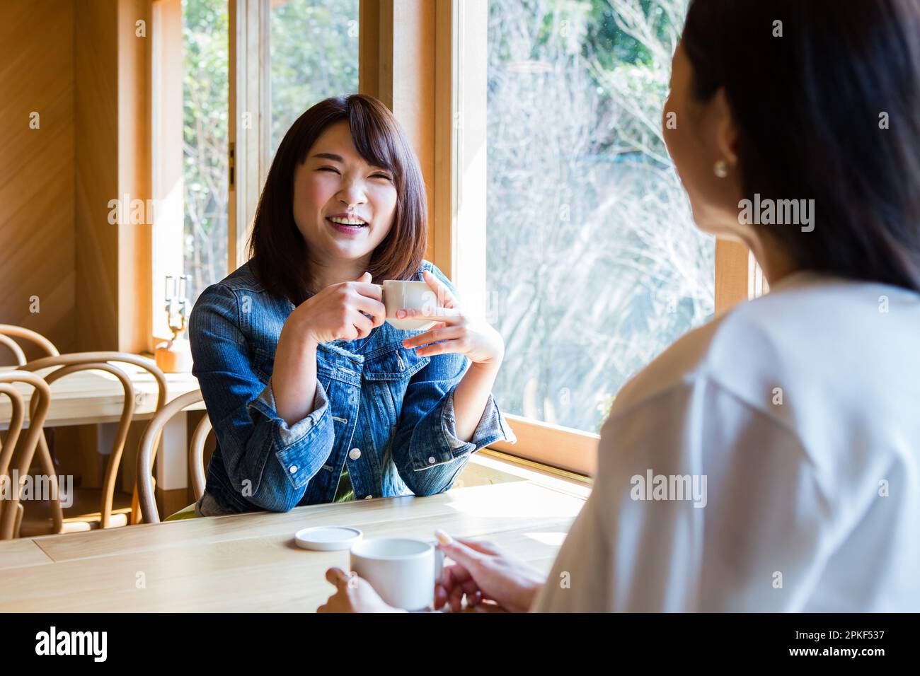 Women talking in cafe Stock Photo - Alamy