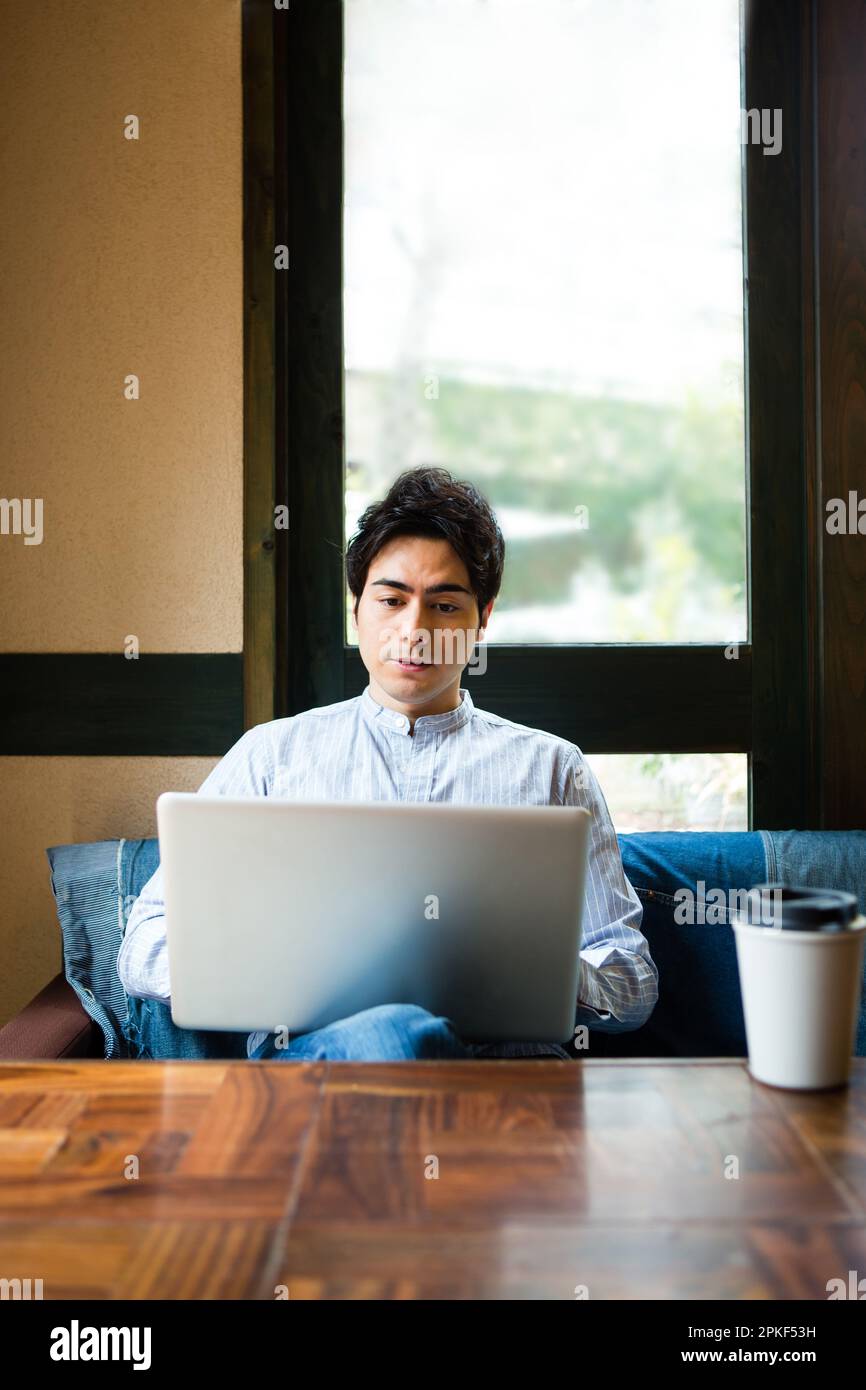 Men using computers at a café Stock Photo - Alamy