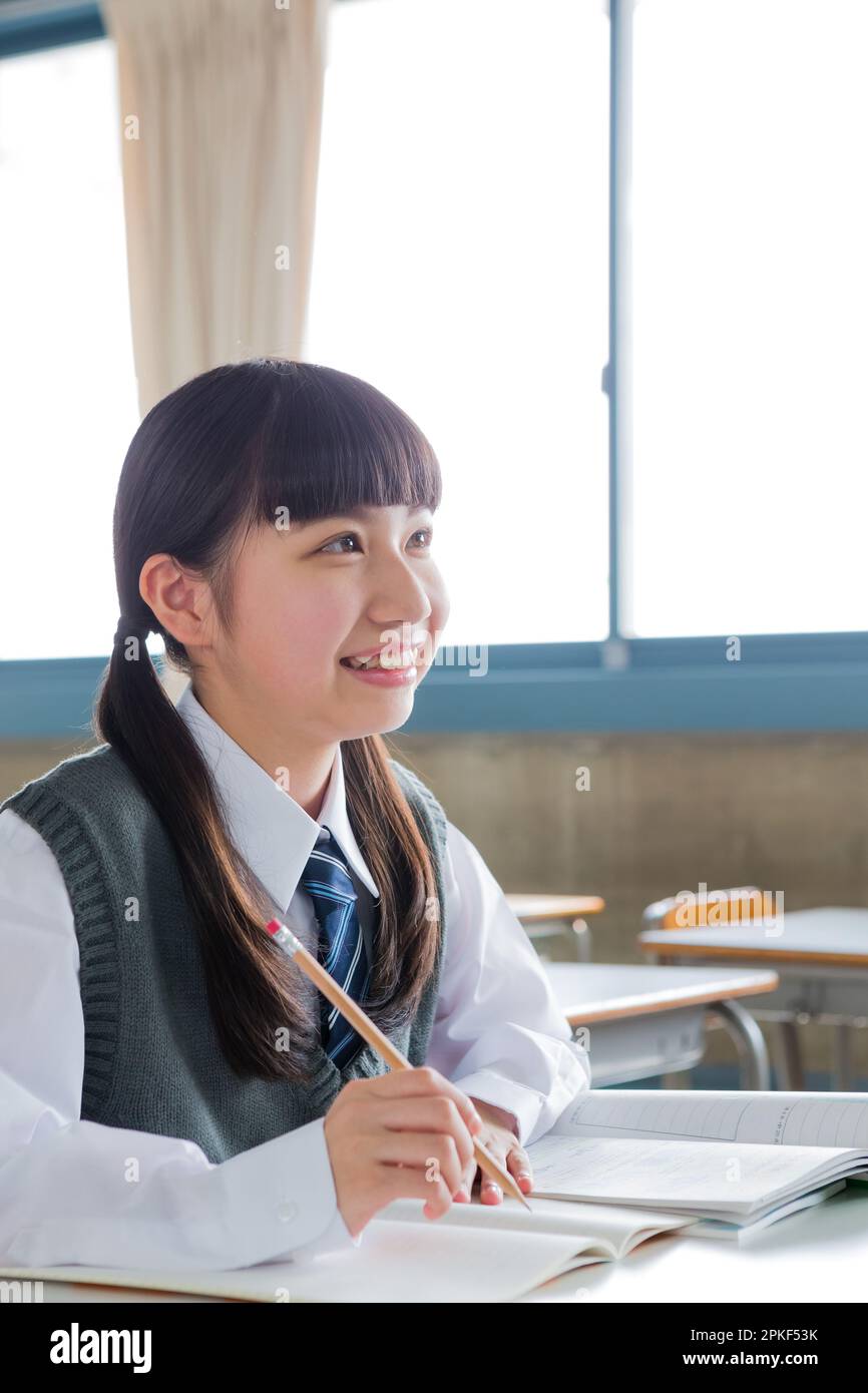 Junior high school girl studying in a classroom Stock Photo - Alamy