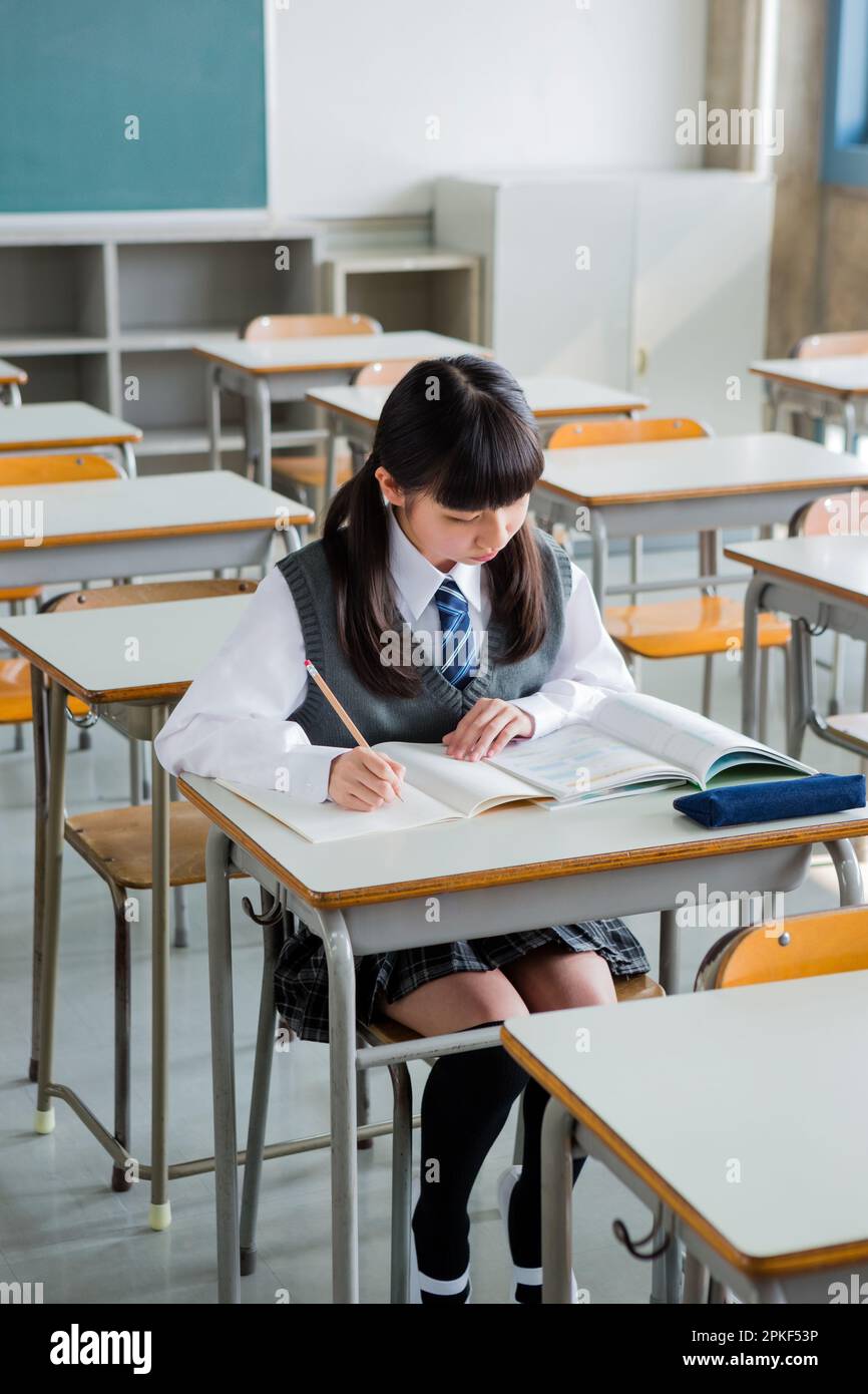 Junior high school girls studying in a classroom Stock Photo - Alamy
