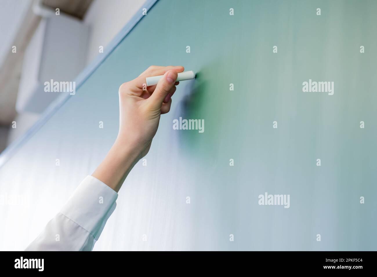 Junior high school girl writing with chalk on the blackboard Stock ...