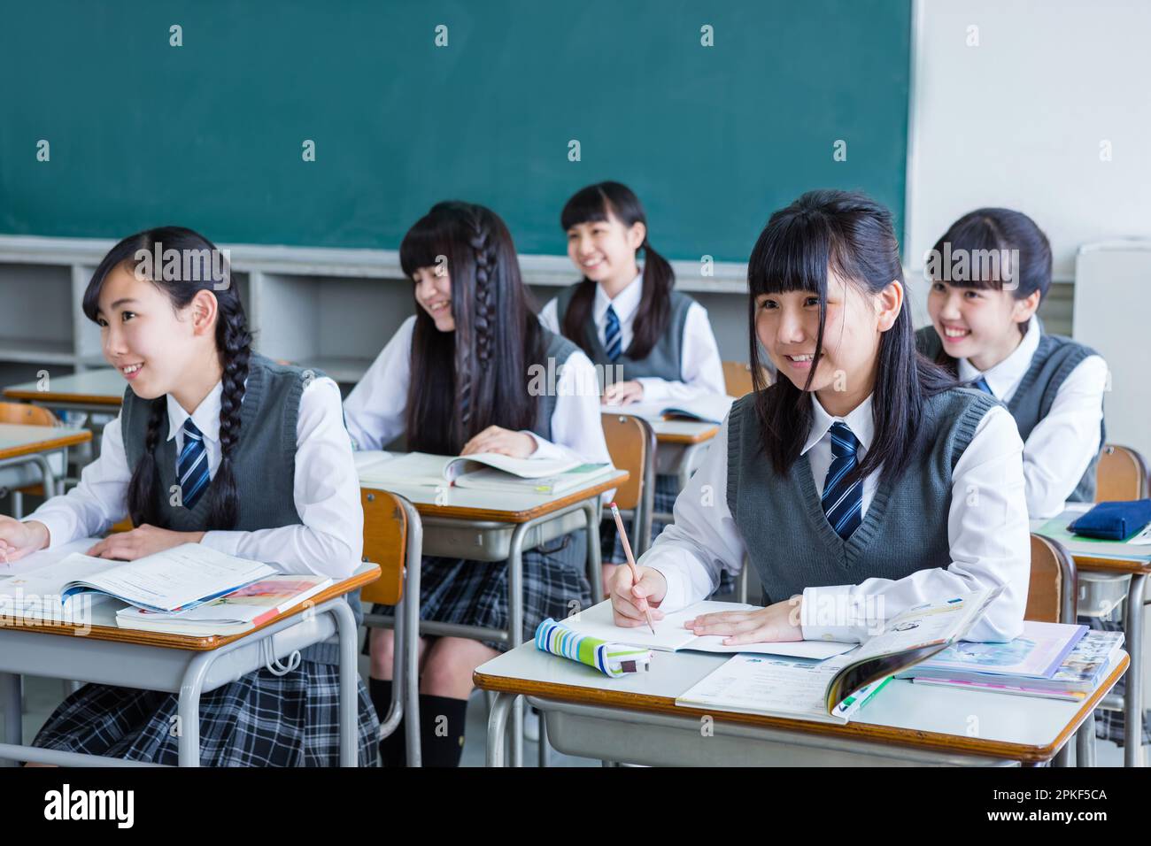 Junior high school girls taking a class Stock Photo - Alamy