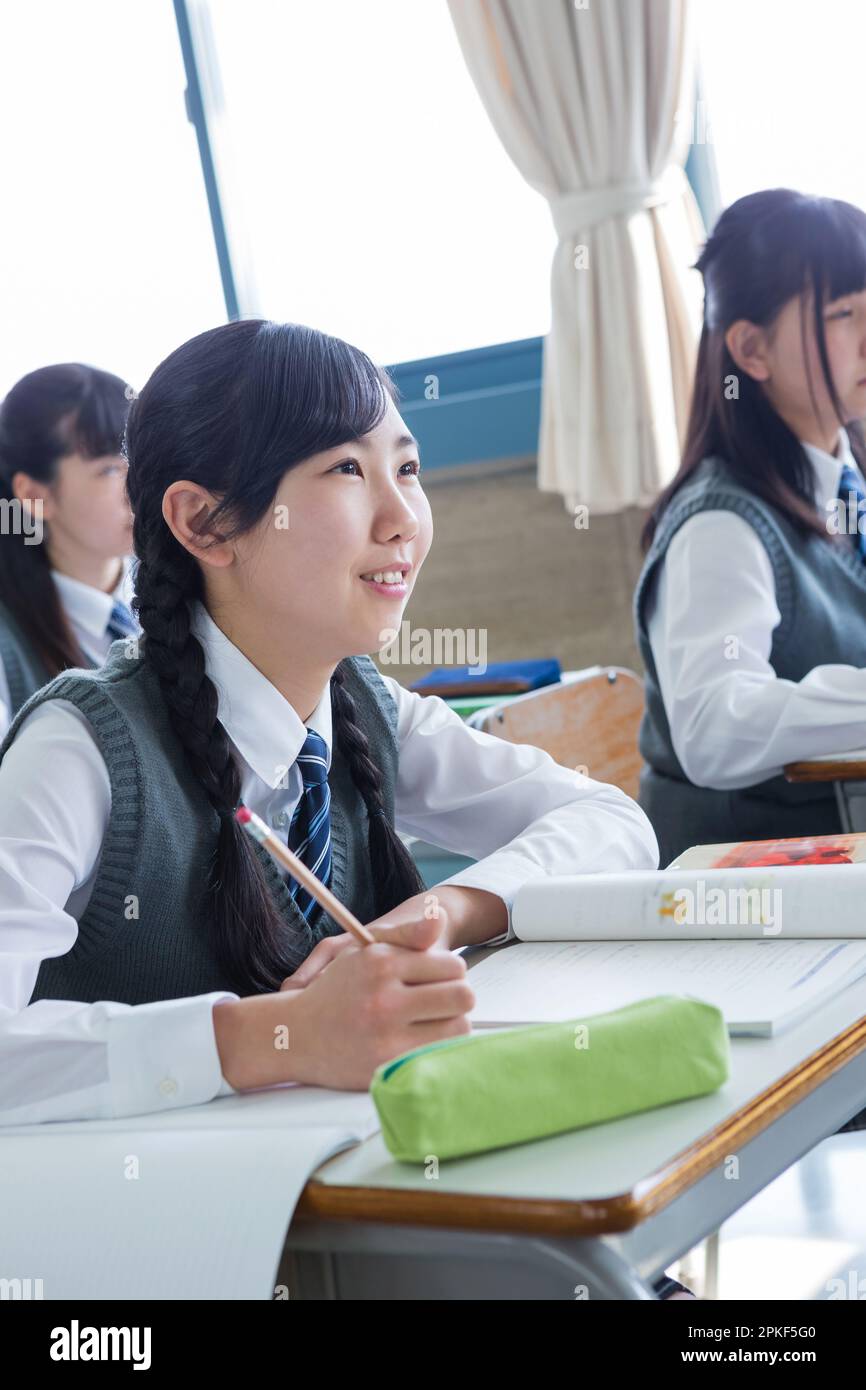 Junior high school girls taking a class Stock Photo - Alamy