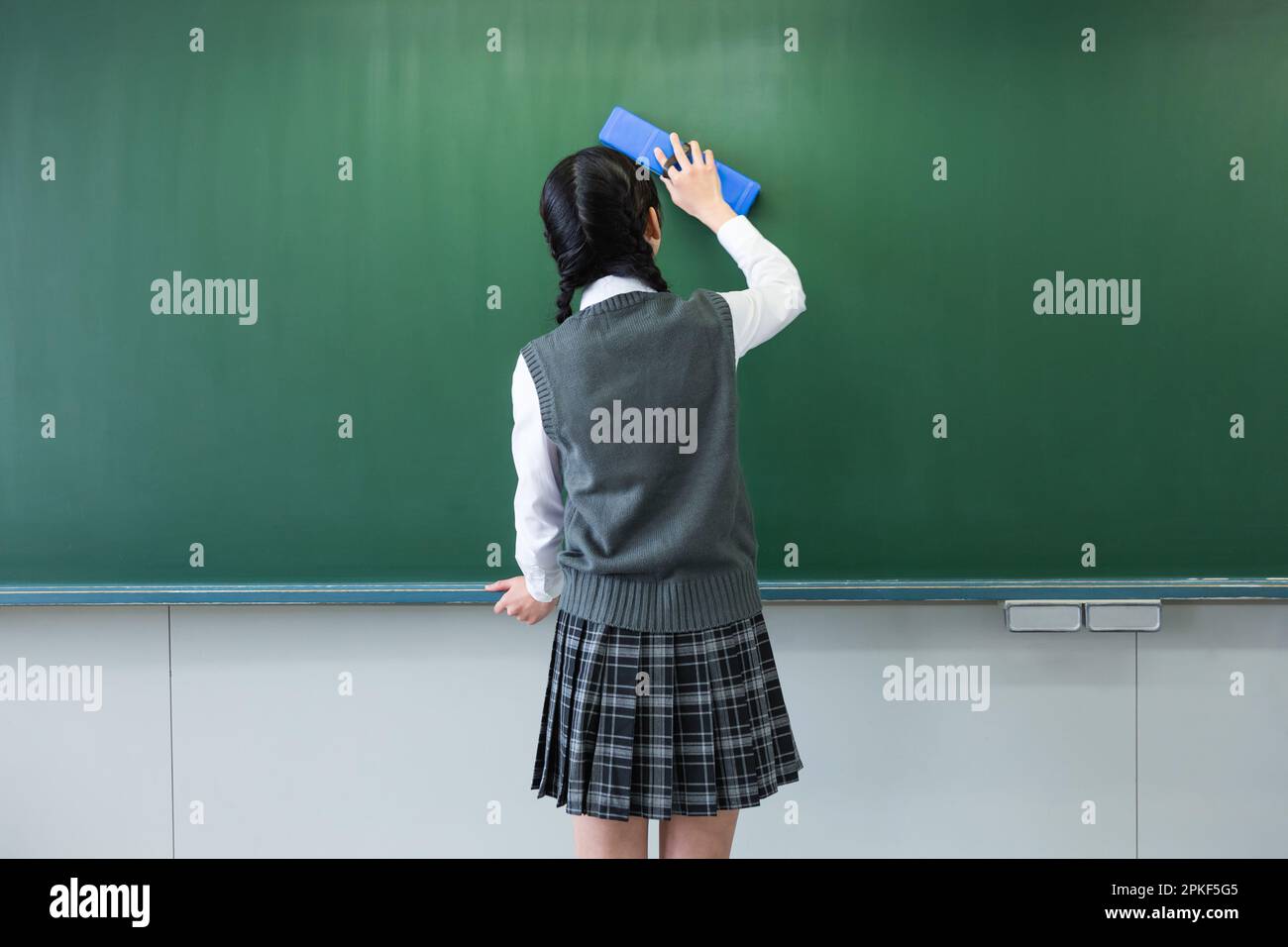 Junior high school girl writing with chalk on the blackboard Stock ...
