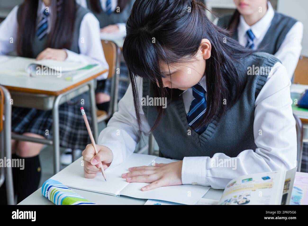 Junior high school girls taking a class Stock Photo - Alamy