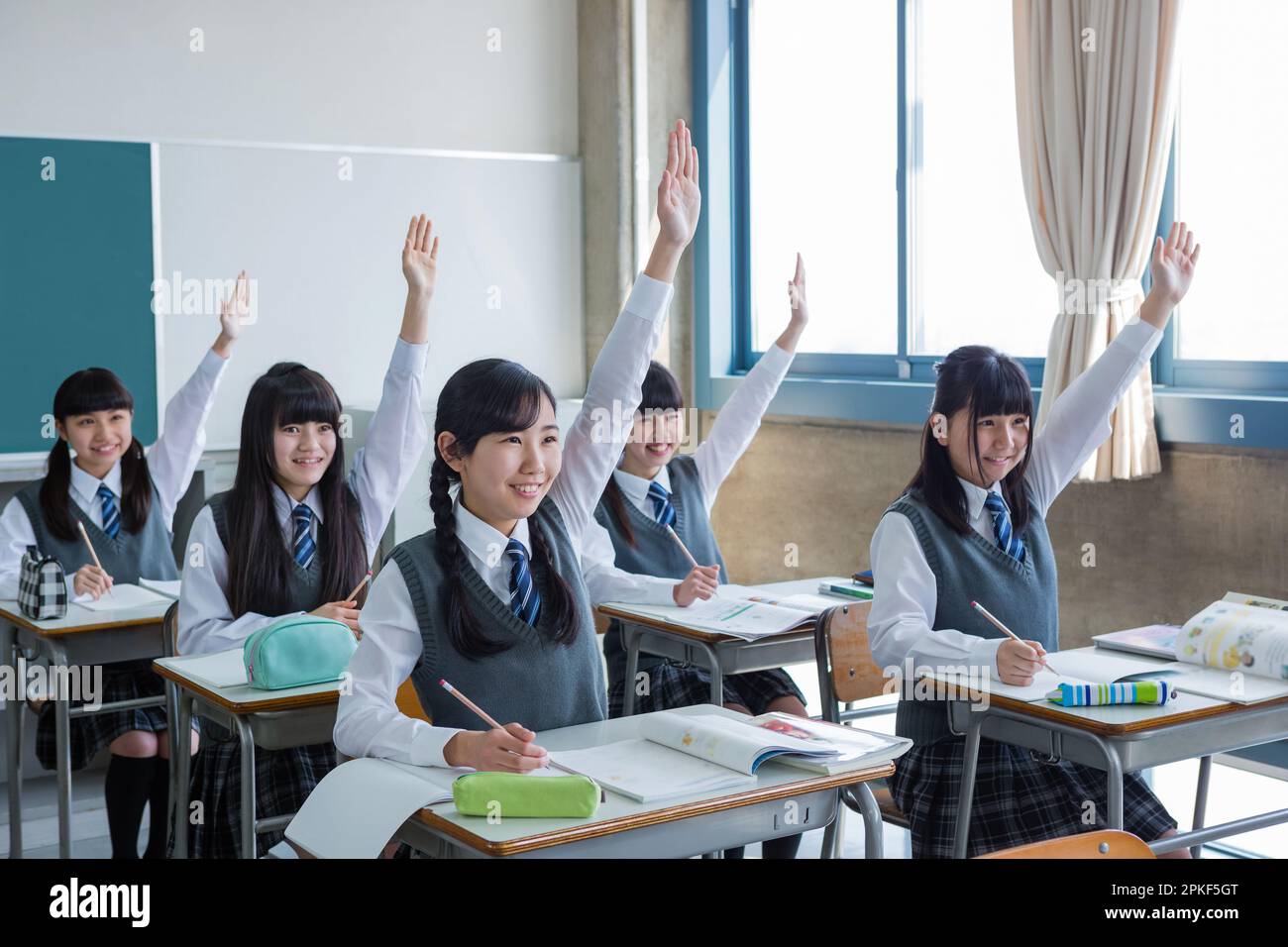 Junior high school girls taking a class Stock Photo - Alamy